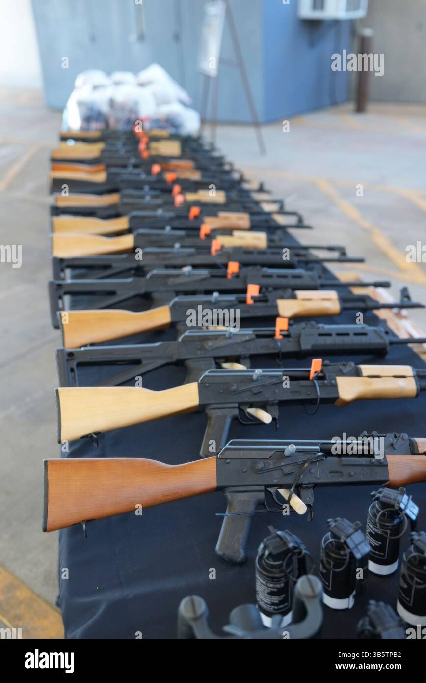 Seized weapons and other munitions sit on display during a press ...