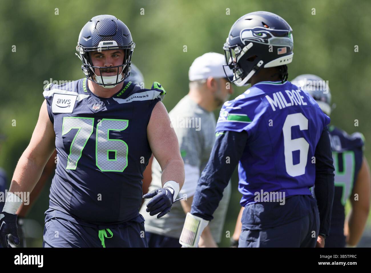 Seattle Seahawks guard Grey Zabel, left, and quarterback Jalen Milroe ...