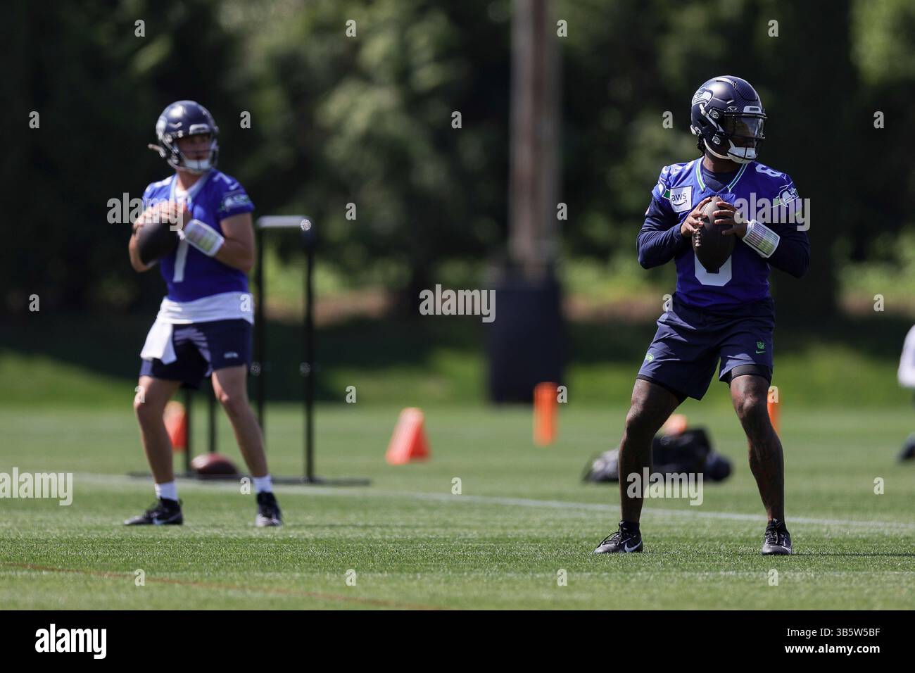 Seattle Seahawks quarterbacks Jalen Milroe, right, and Will Rogers ...