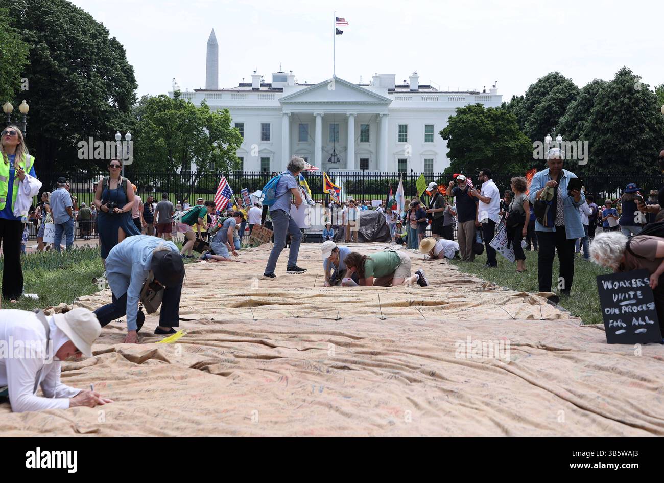 May Day Protest in Washington, USA - 01 May 2025. Protesters sign a ...