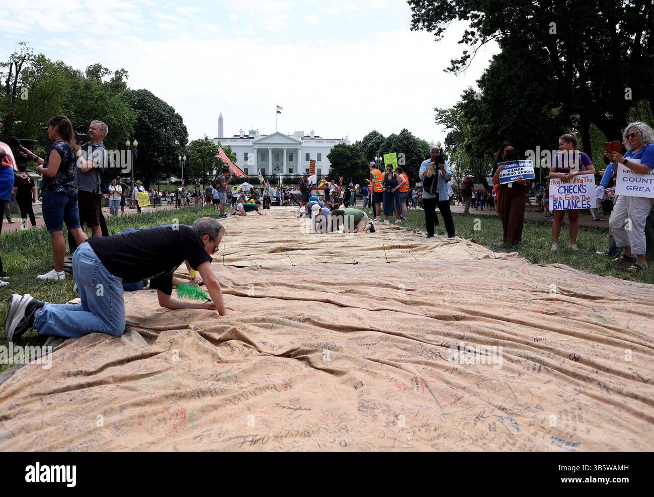 May Day Protest in Washington, USA - 01 May 2025. Protesters sign a ...