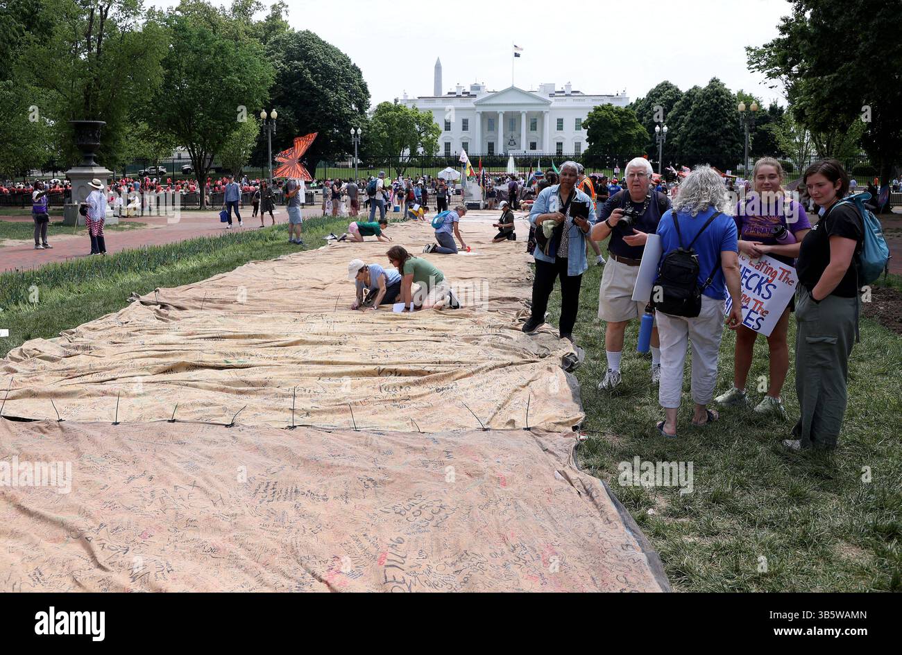 May Day Protest in Washington, USA - 01 May 2025. Protesters sign a ...