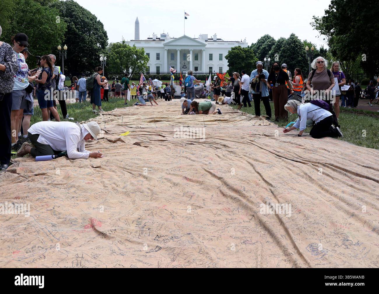 May Day Protest in Washington, USA - 01 May 2025. Protesters sign a ...