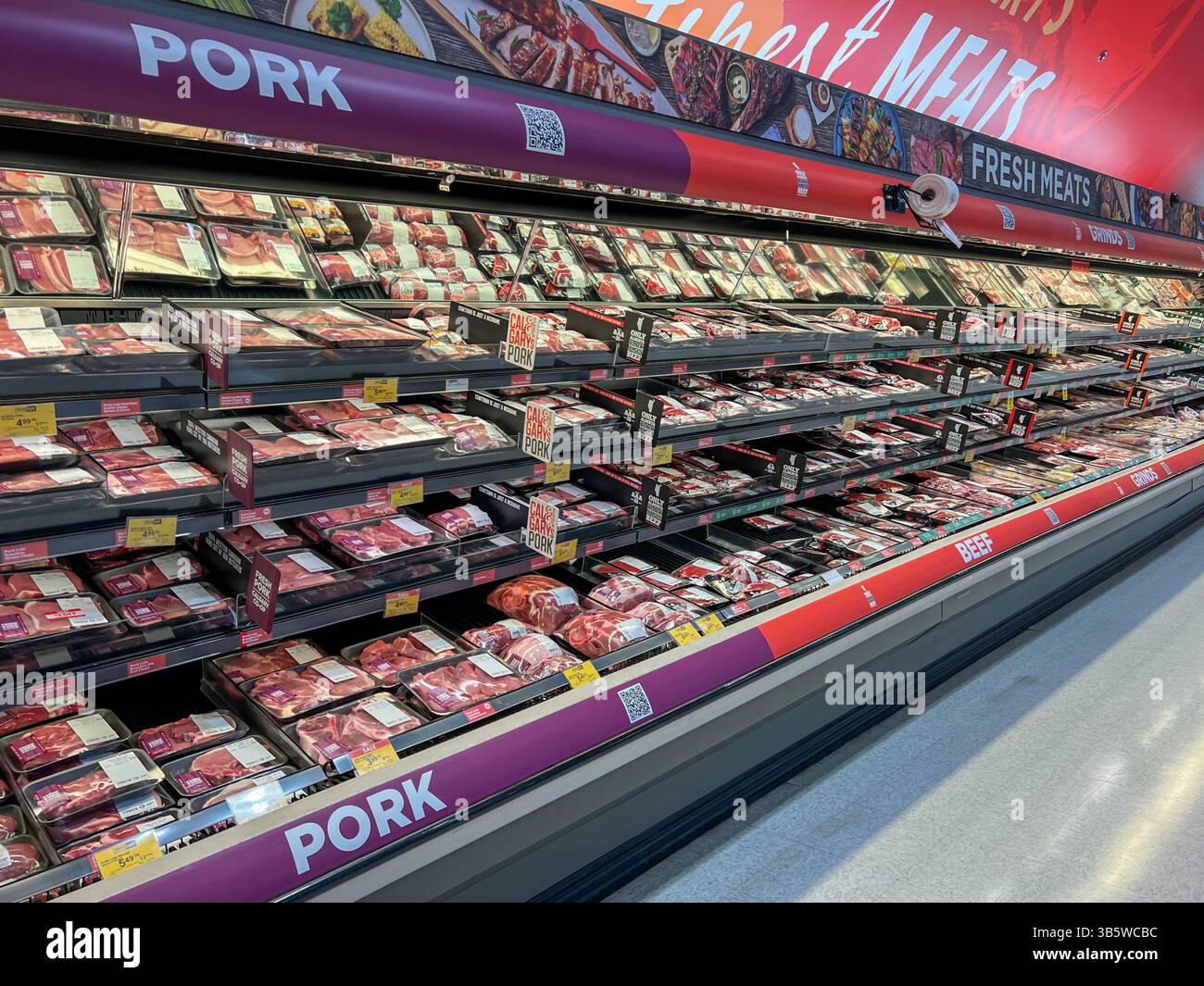 Varieties of packaged raw meat on the shelves in a supermarket. Alberta ...