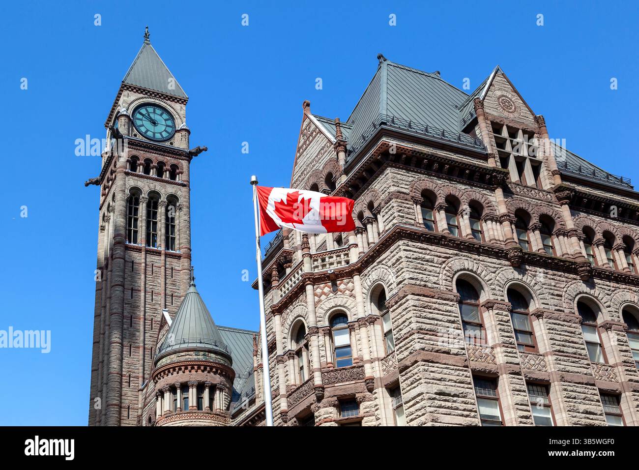 The waving Canadian flag with Old City Hall in background in Toronto ...