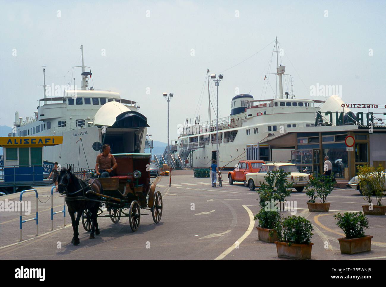 Ferries, cars, and a horse-drawn carriage at Portoferraio harbour, Elba ...