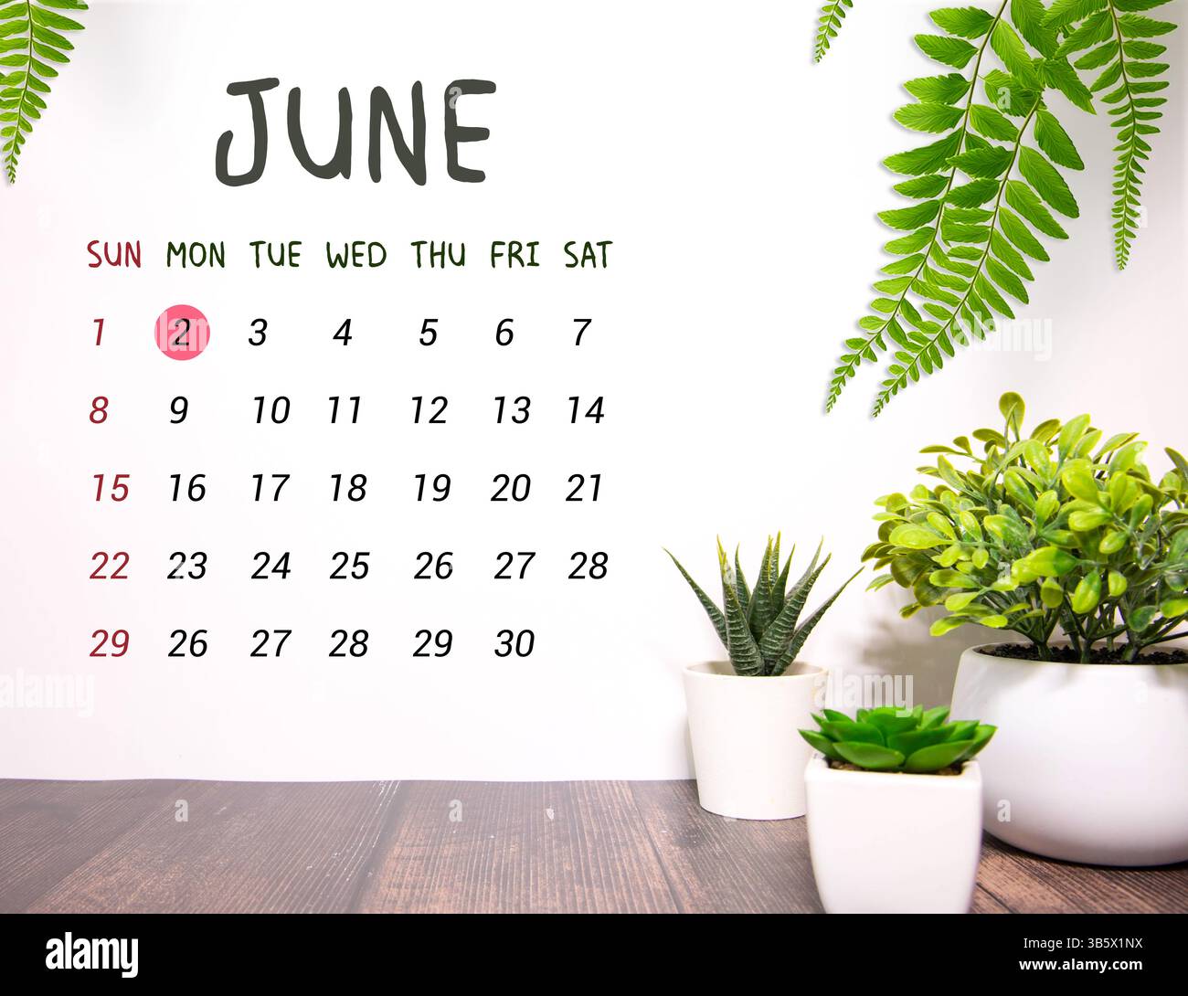 Cube shape calendar for June 02 on wooden surface with empty space for ...