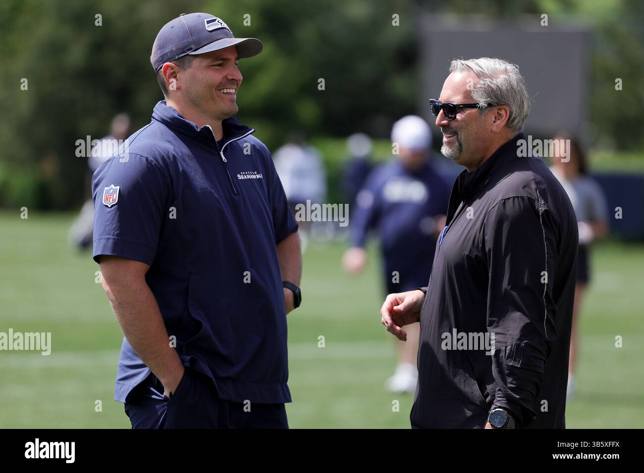 Seattle Seahawks head coach Mike Macdonald, left, speaks with chief ...