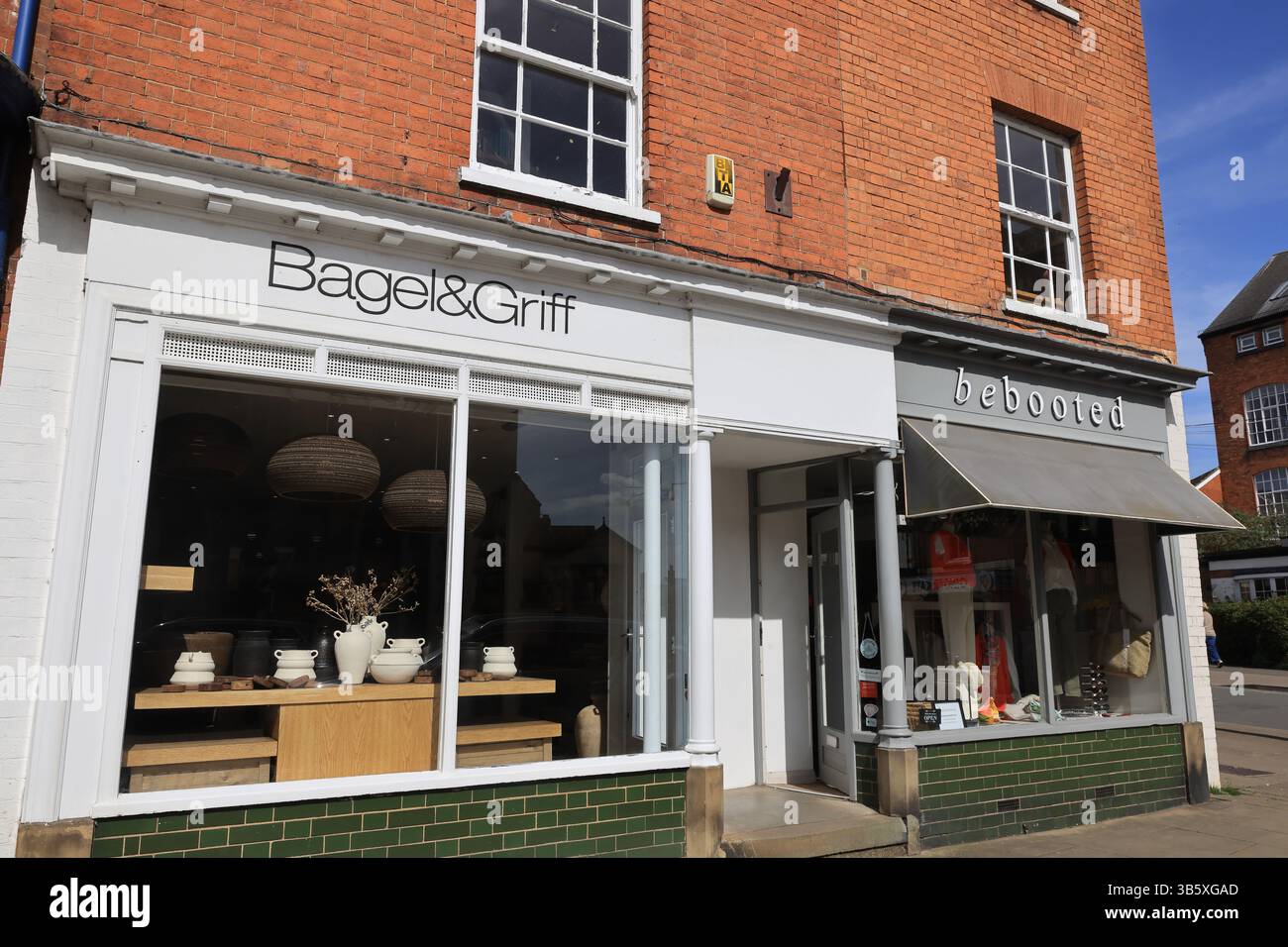 Upmarket shops on Church Square in market town Market Harborough, in ...