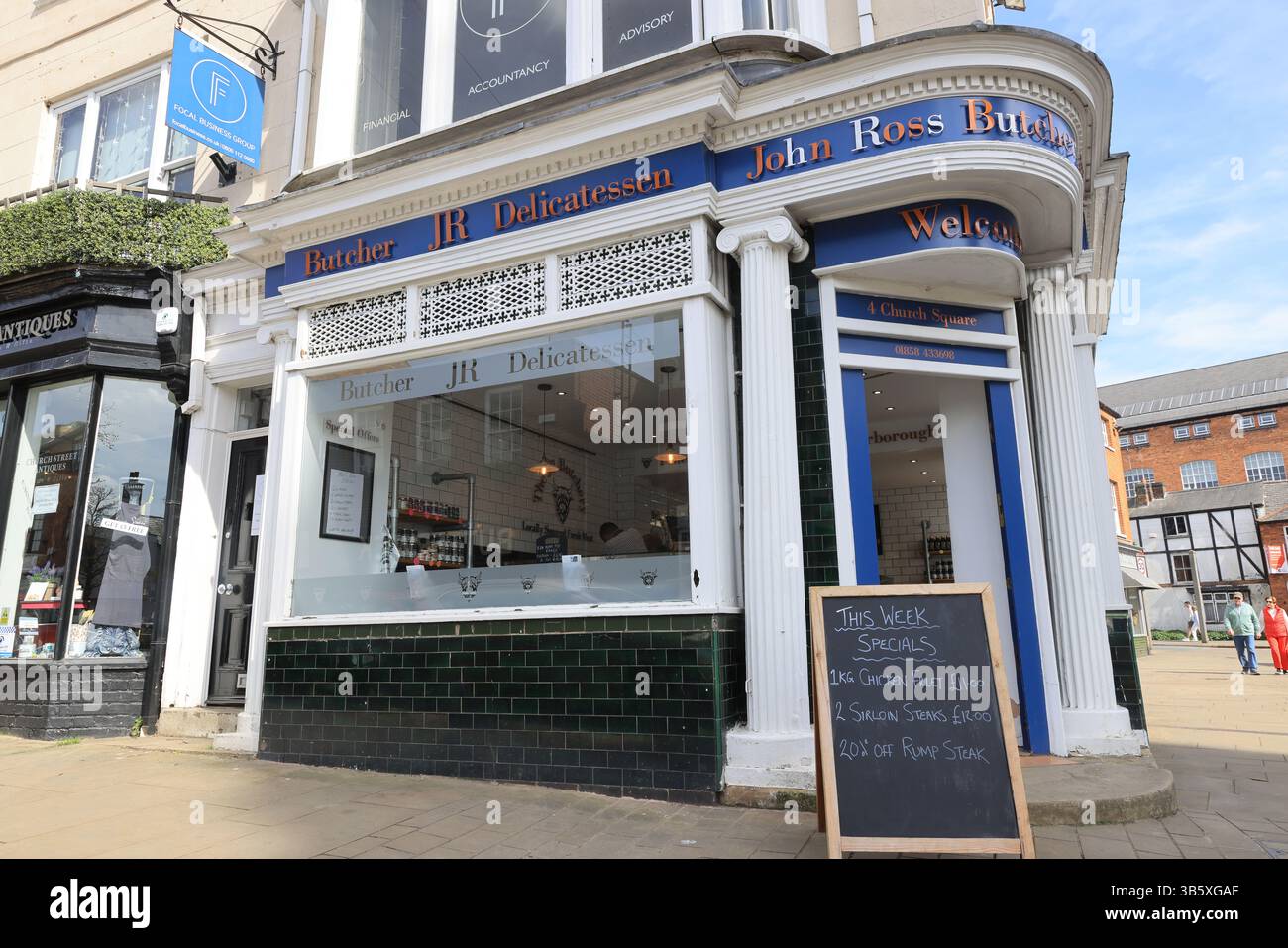 Upmarket shops on Church Square in market town Market Harborough, in ...