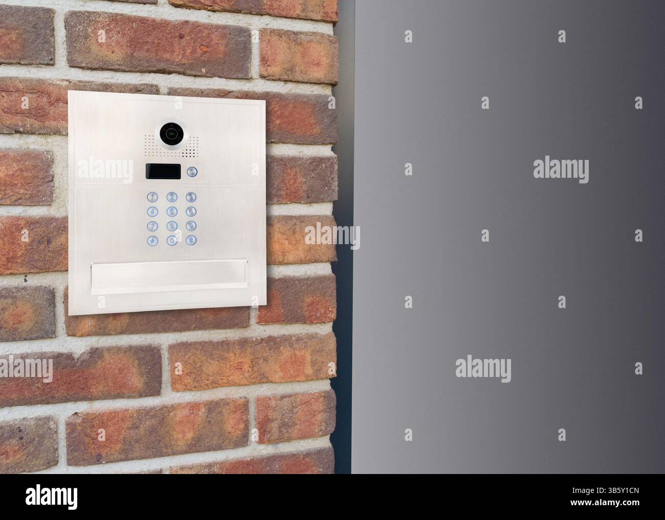 Metal Keypad Intercom on Corner Brick Wall Stock Photo - Alamy