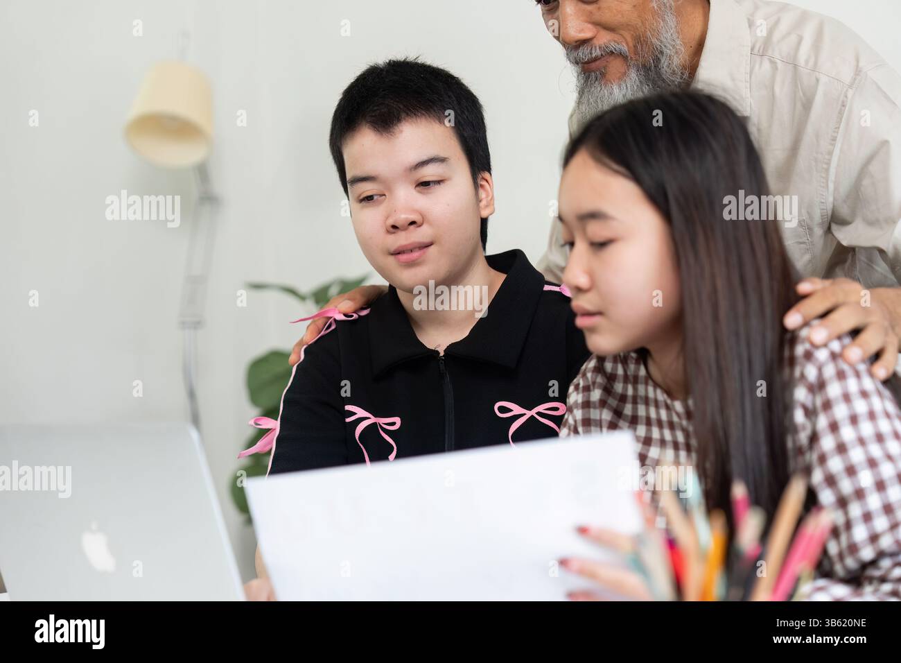 Family Bonding and Learning. A girl with Down syndrome shares a ...