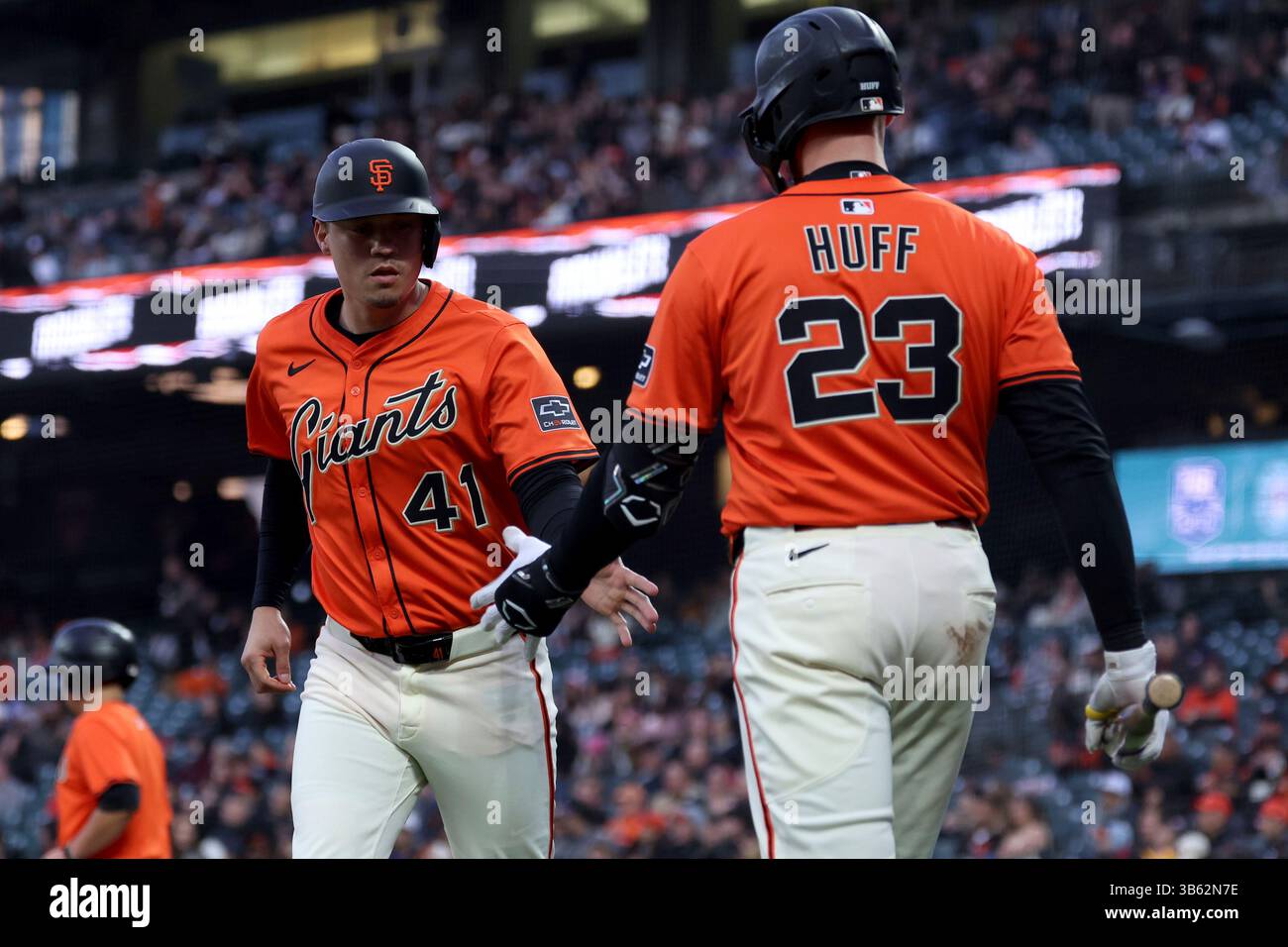 San Francisco Giants' Wilmer Flores (41) is congratulated by Sam Huff ...