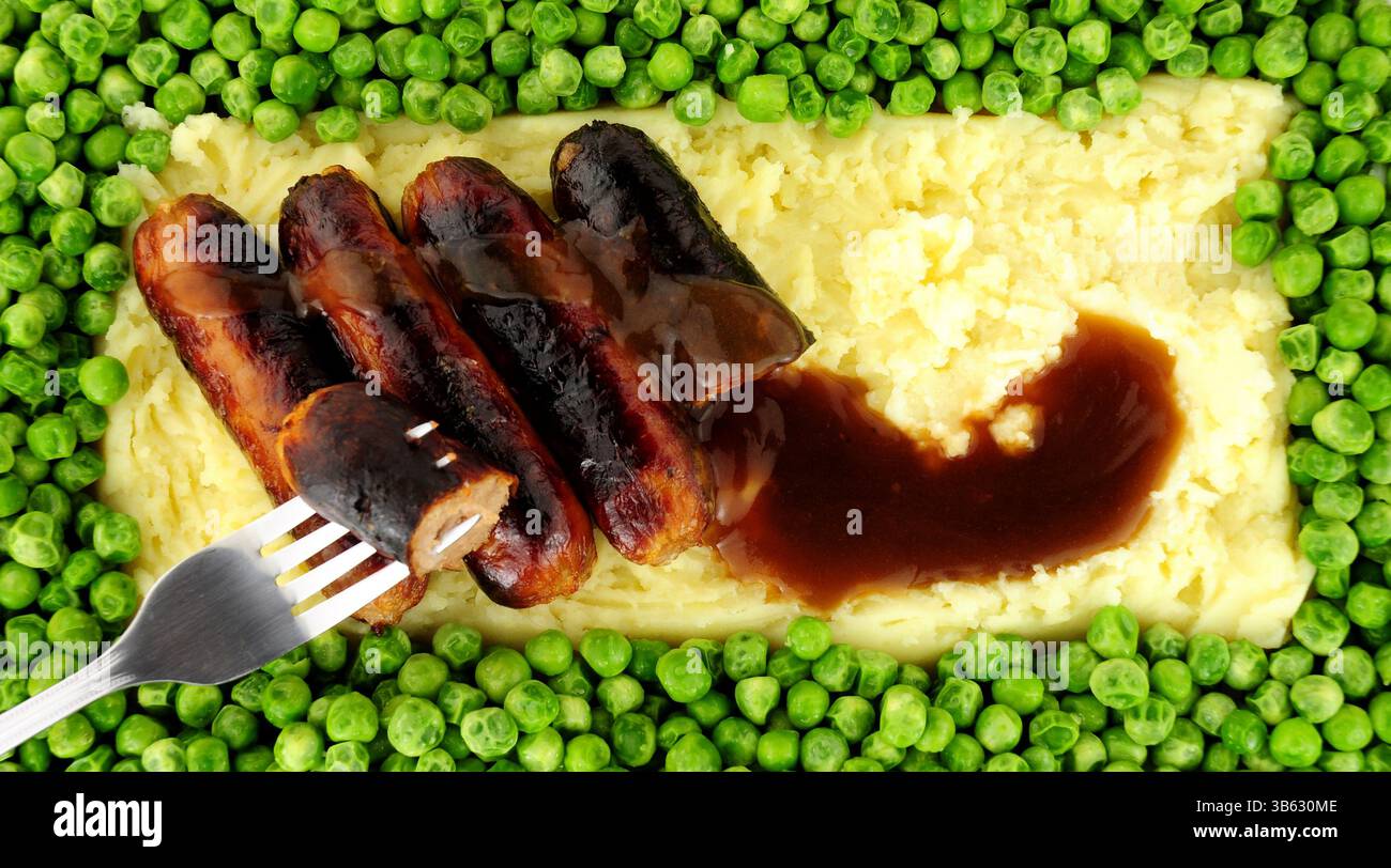 Pork sausages and mashed potato meal with a garden pea border ...