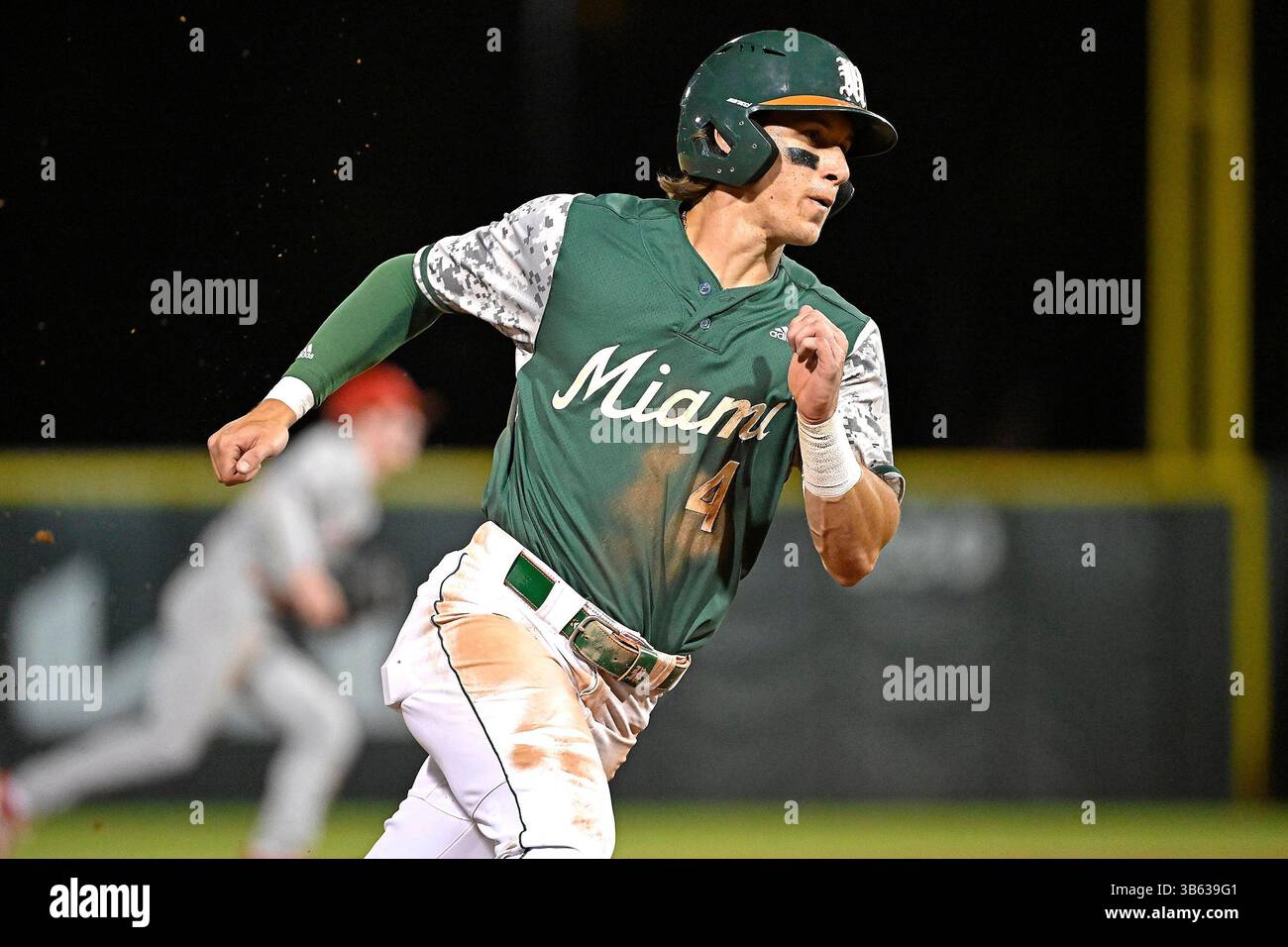 CORAL GABLES, FL - MAY 02: Miami infielder Jake Ogden (4) runs to third ...