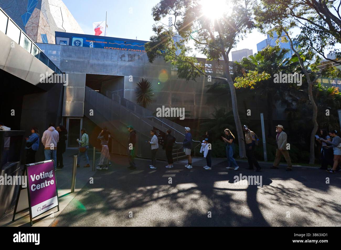 Voters stand in line outside a polling centre on election day during ...