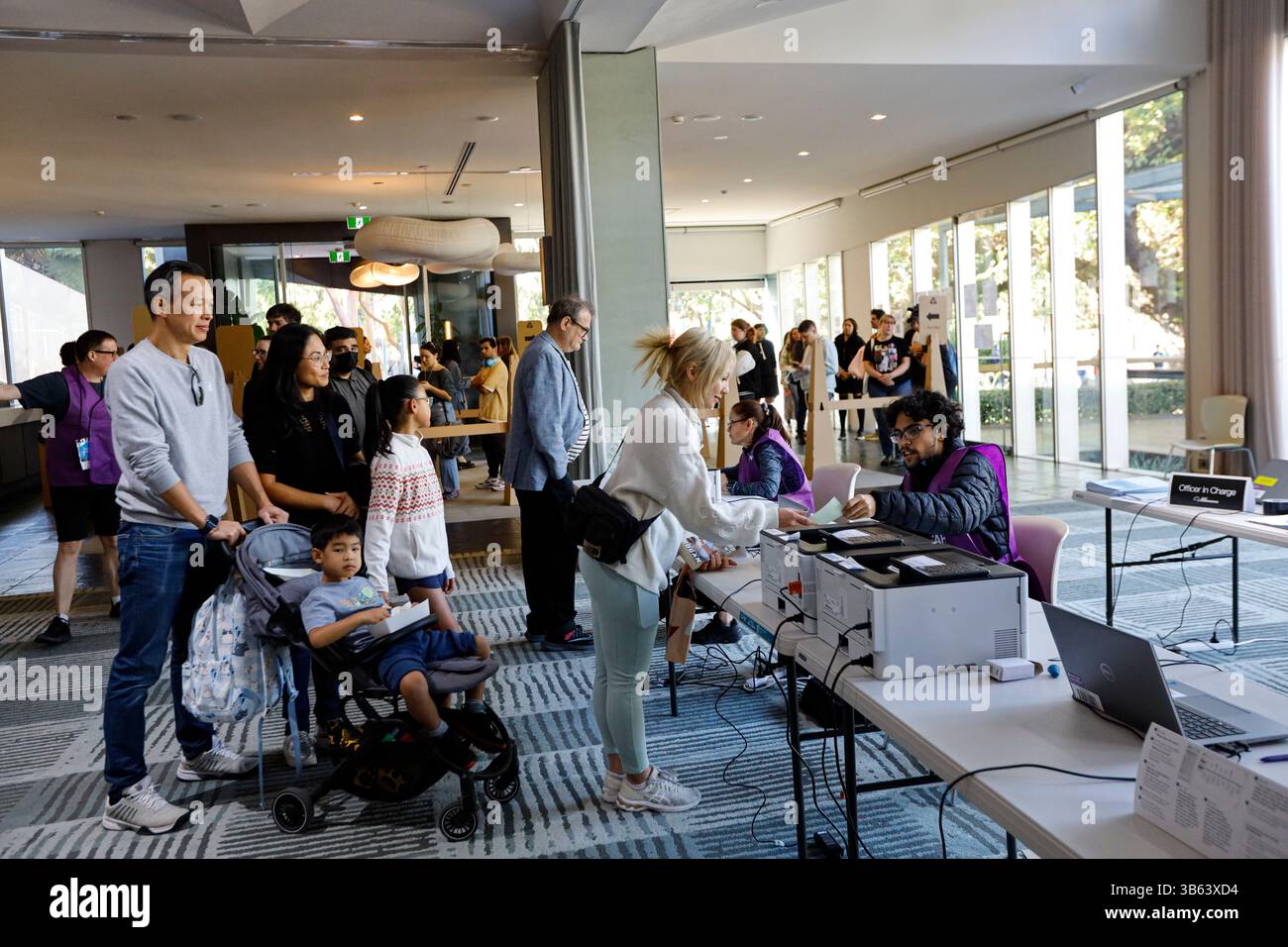 Voters register with Australian Electoral Commission (AEC) staff at a ...