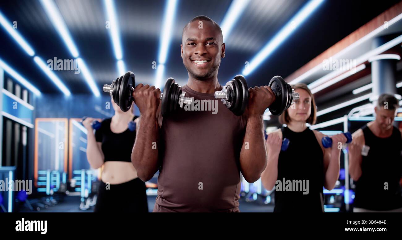 Group Fitness Class In Gym: Diverse People Lifting Weights Together ...