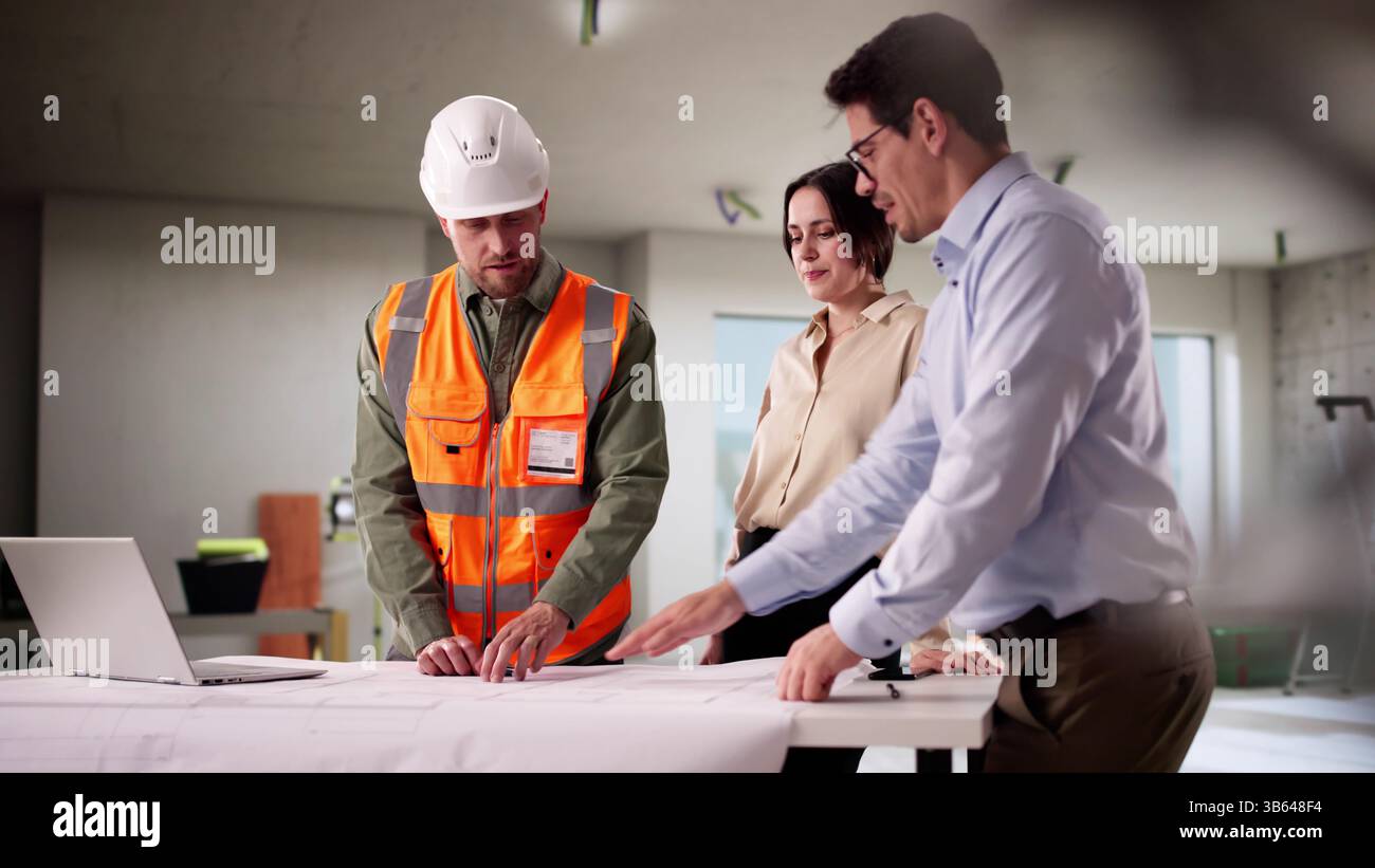 Professional Engineers Inspecting House Blueprint With Young Couple In ...