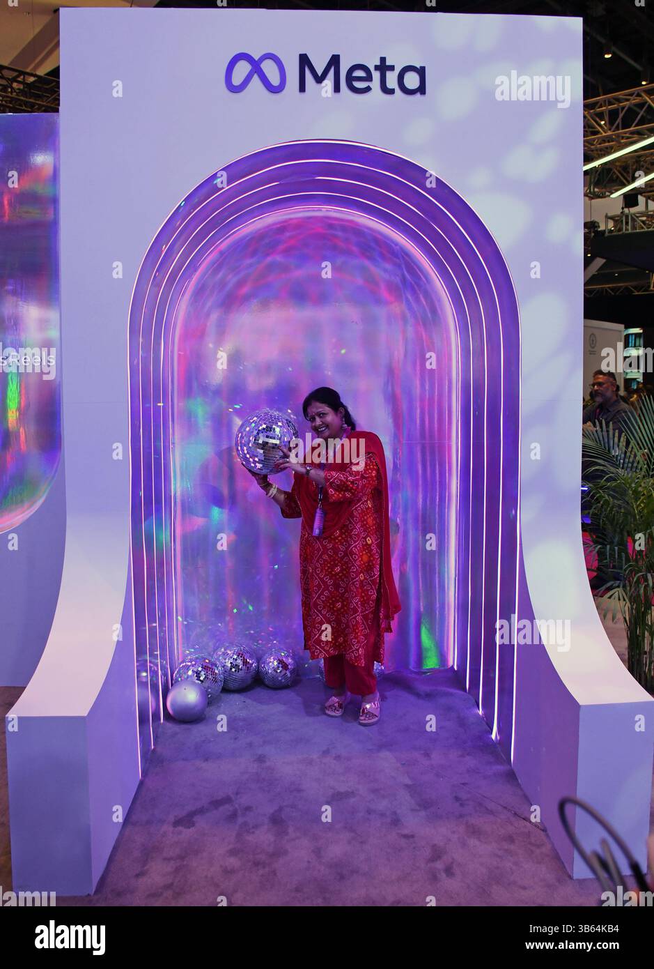 A woman poses for a photo at the Meta stall at the World Audio Visual ...