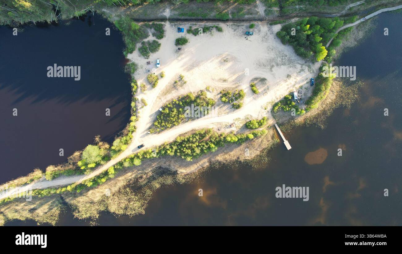 Remote Sandy Peninsula Surrounded by Calm Dark Water Seen from Drone ...