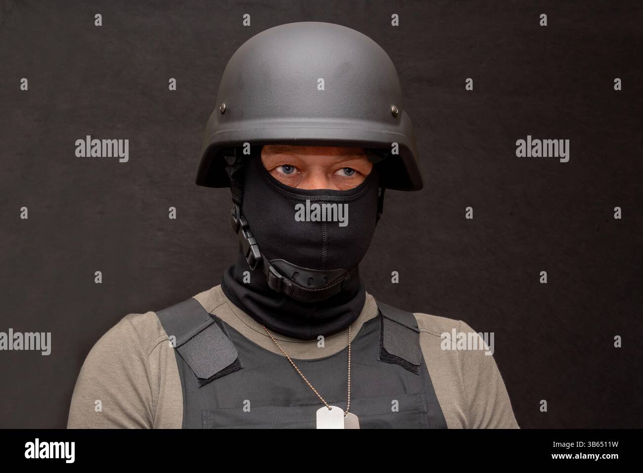 Tactical military man in body armour and helmet with identification ...