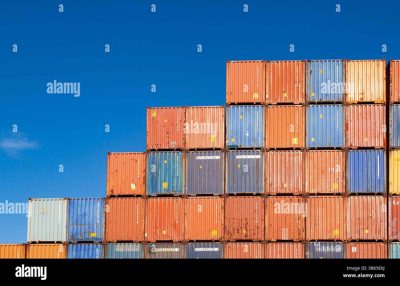 Multi-colored shipping containers stacked on top of each other Stock ...