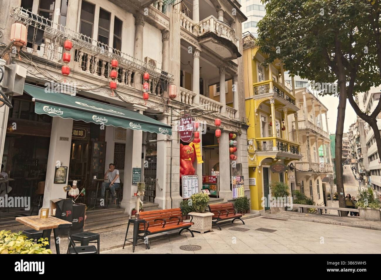 Old town street in Macau, historical chinese and portuguese buildings ...