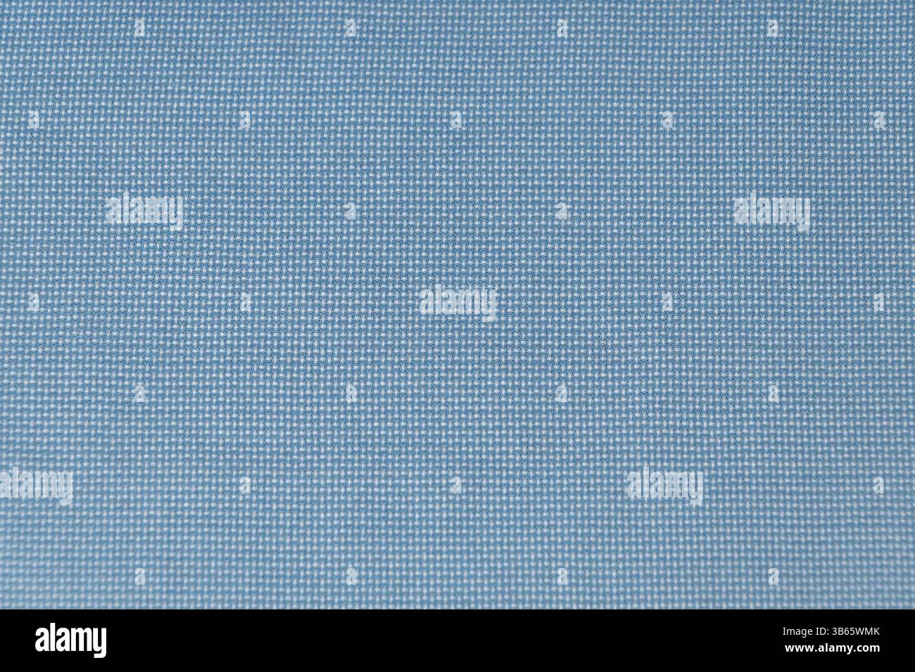 A close-up of blue woven fabric with a uniform grid pattern and a ...