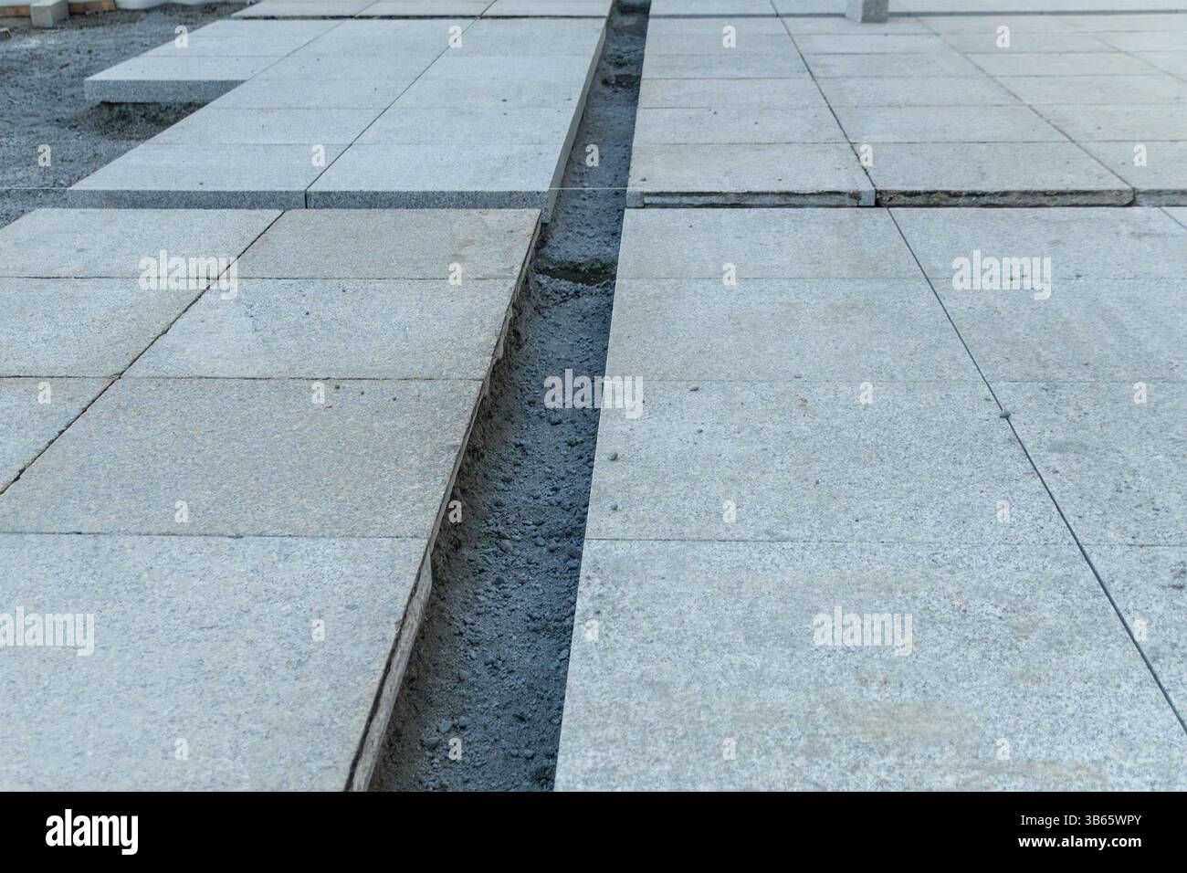 Concrete pavement under construction with visible gaps and gravel ...