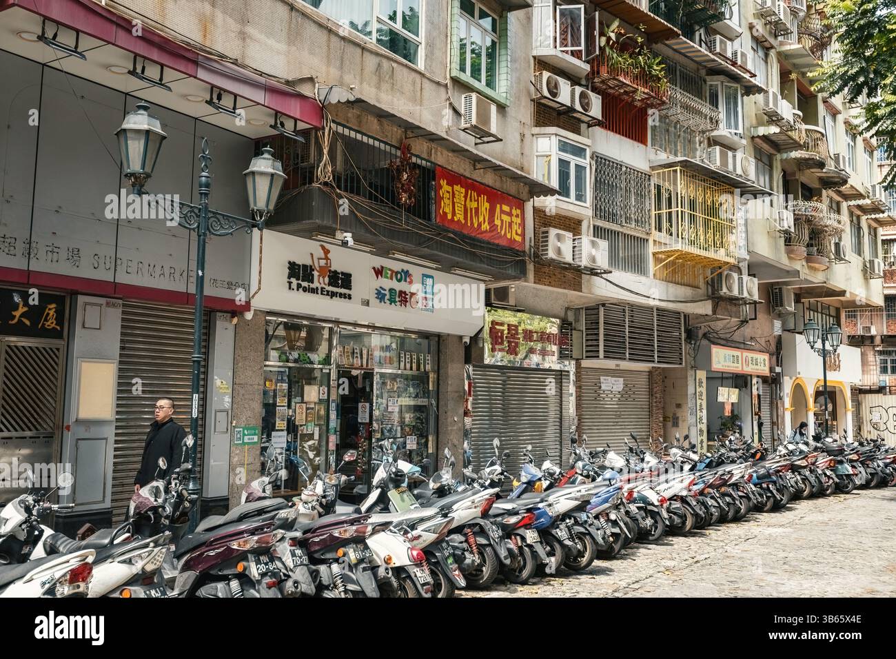Old town street in Macau, historical chinese and portuguese buildings ...