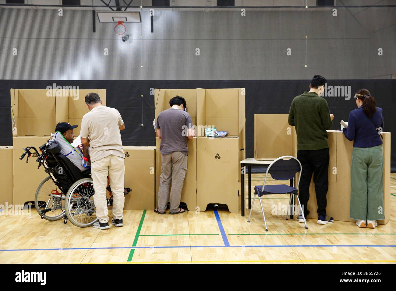 Voters mark their ballot papers in private booths on election day ...