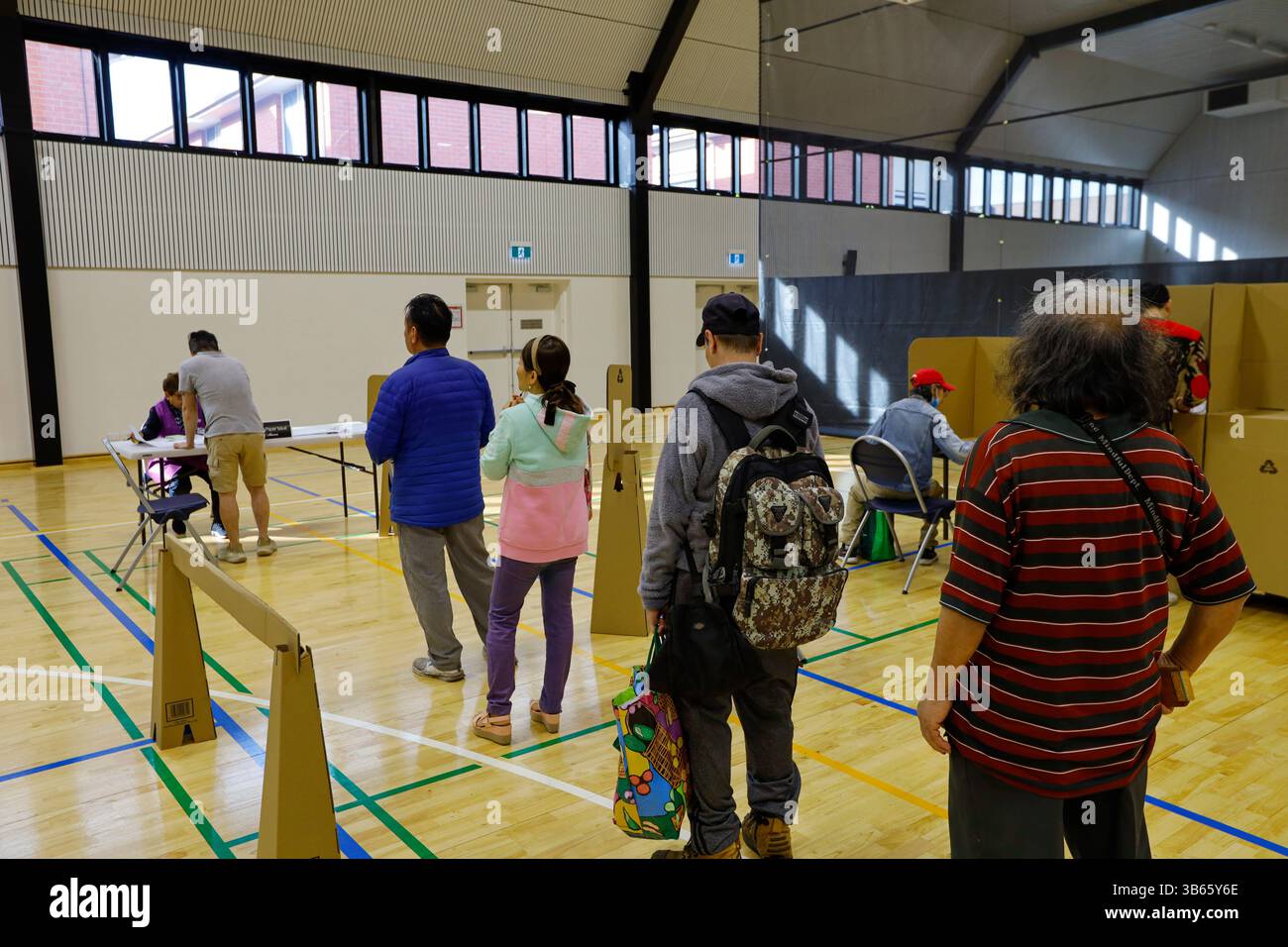 Voters line up inside to register before casting their ballots during ...