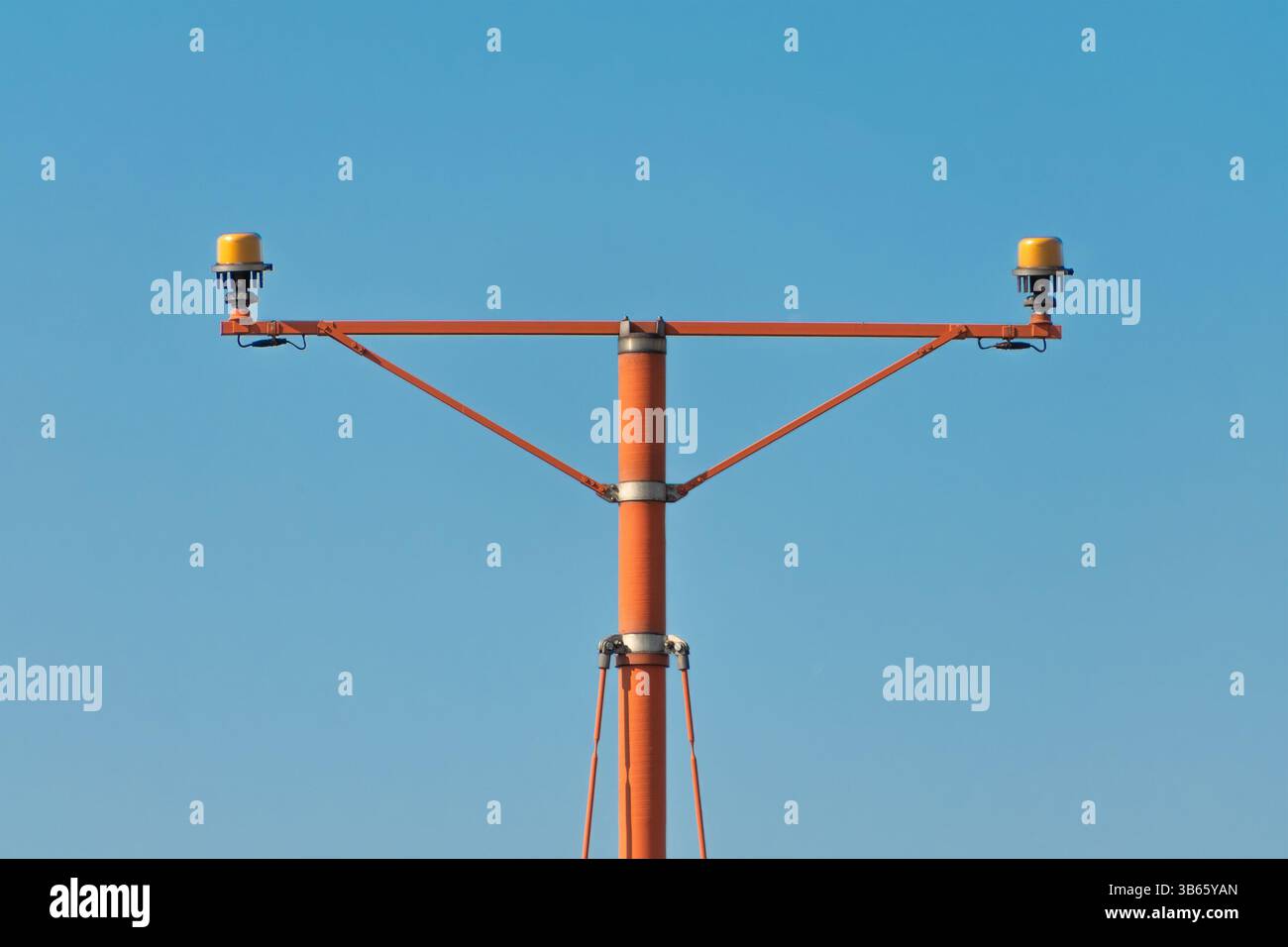 Airport approach lighting system with orange metal structure and yellow ...