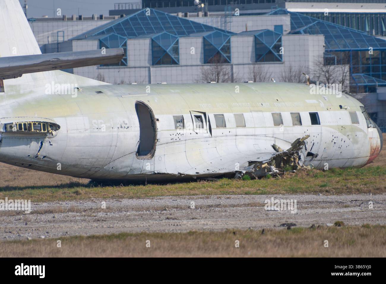 Abandoned aircraft fuselage with missing parts, broken windows, and a ...