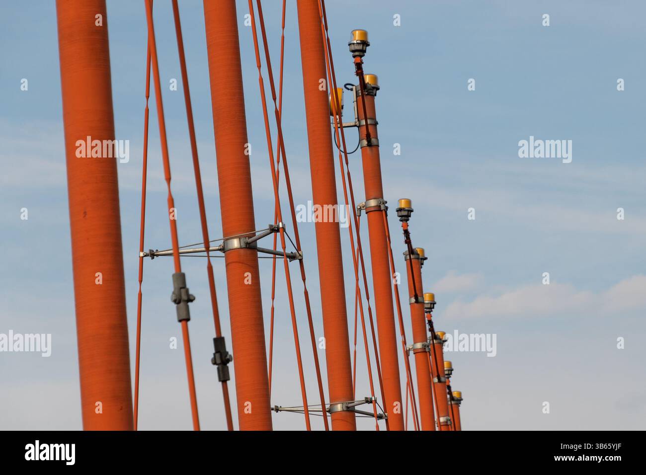 Airport approach lighting system with orange metal structure and yellow ...