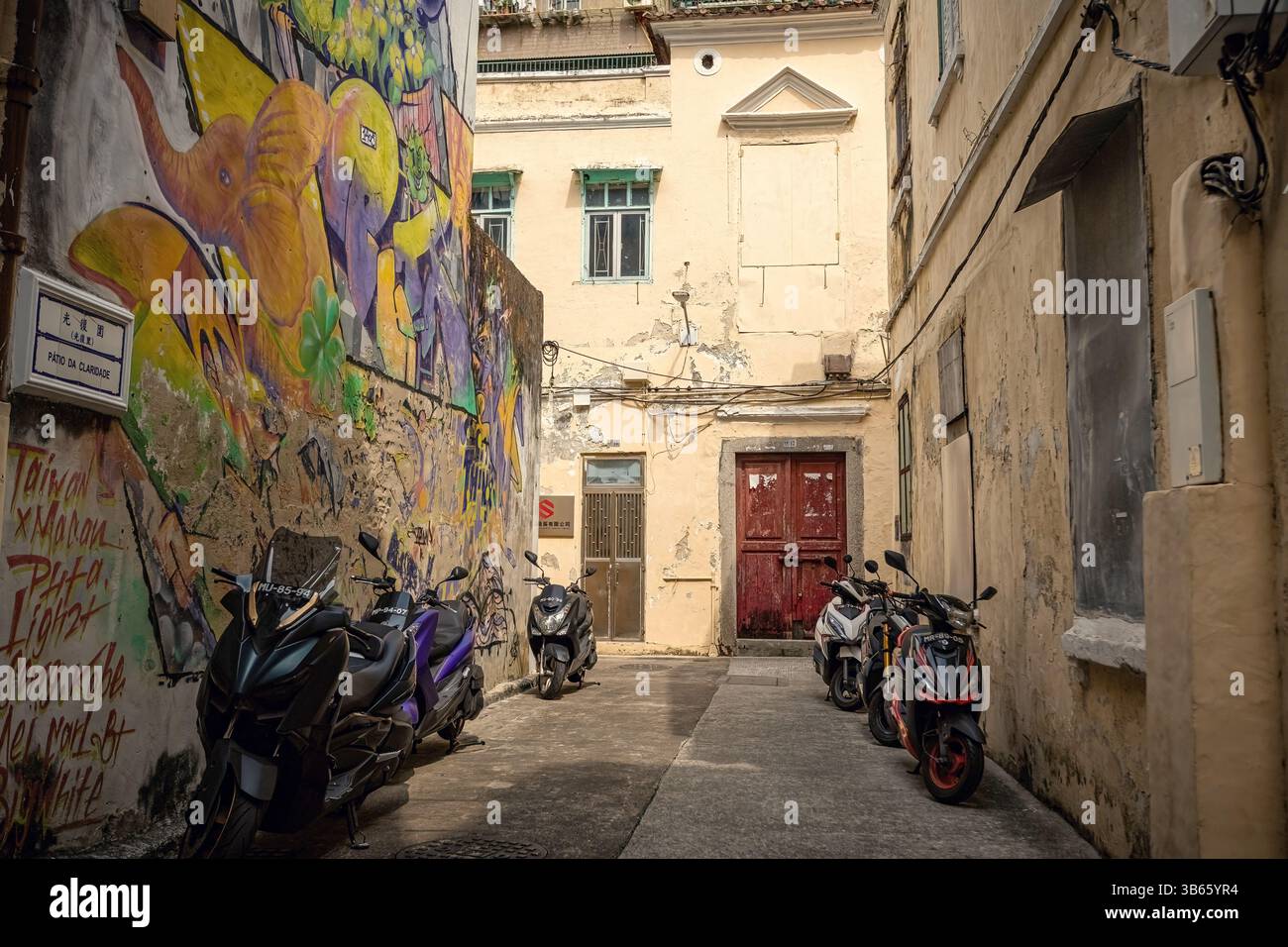 Old town street in Macau, historical chinese and portuguese buildings ...