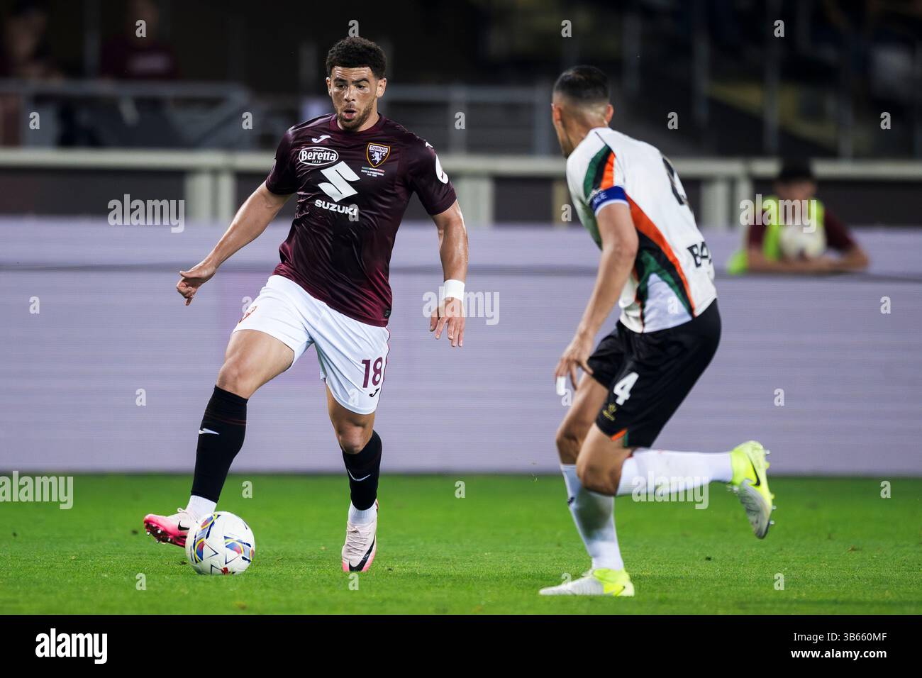 Turin, Italy. 2 May 2025. Che Adams of Torino FC is challenged by Jay ...