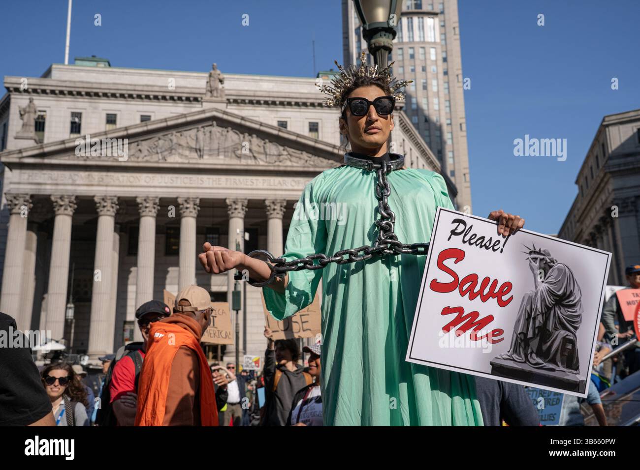 Manhattan, United States. 01st May, 2025. A protester in chains ...