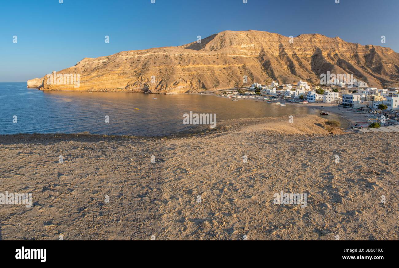 Oman: view at sunset of the stunning beach of Qantab, small traditional ...