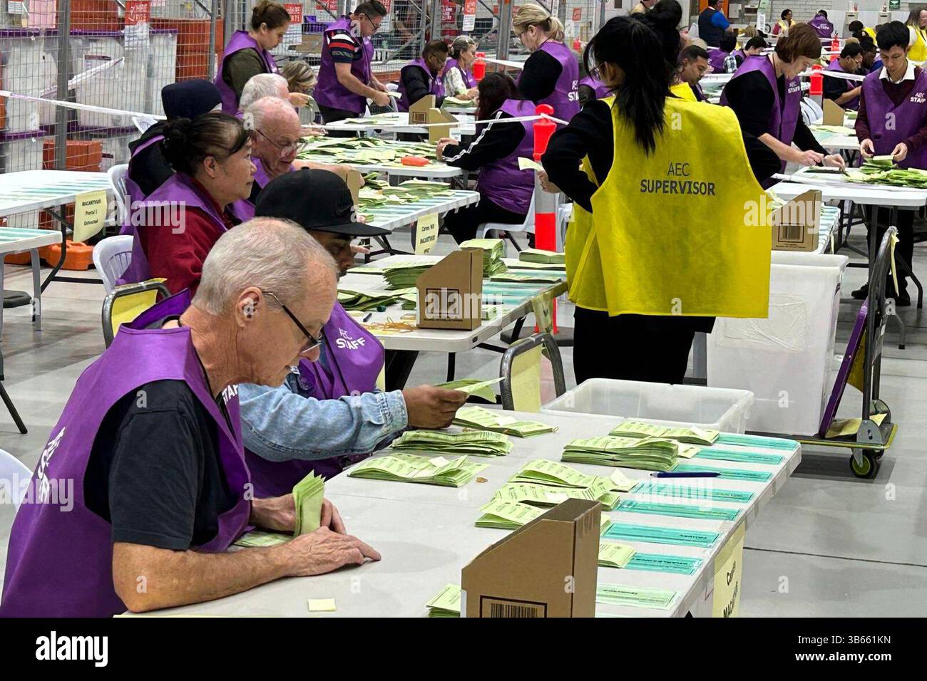Australian Electoral Commission staff begin counting votes at a ...