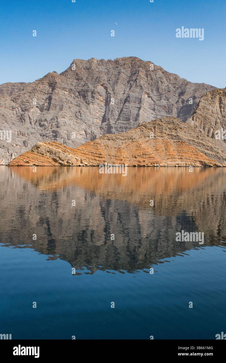 Oman: mountain reflection in the calm waters of the Strait of Hormuz ...