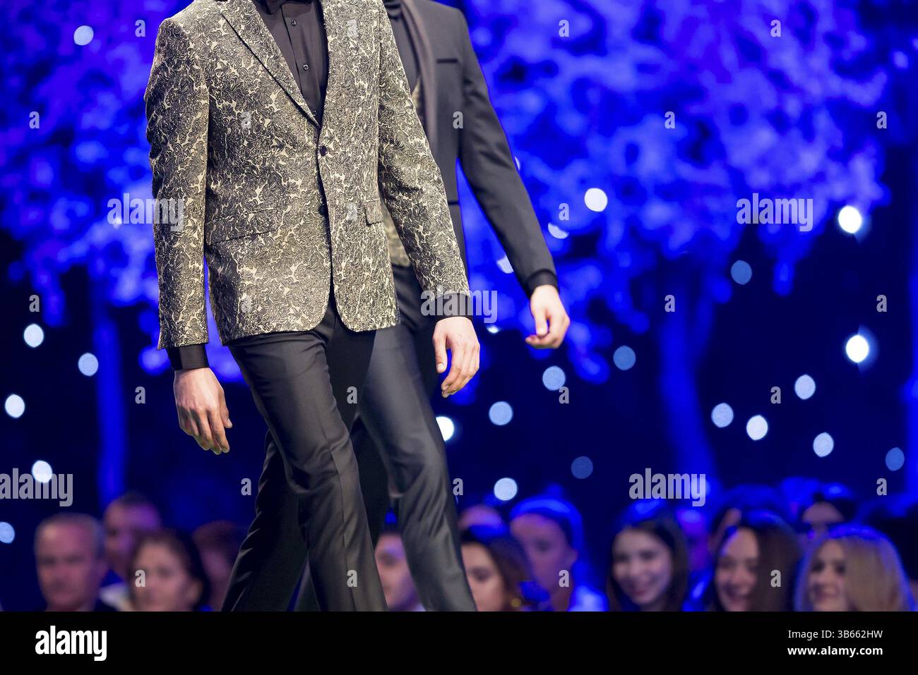 Male models walk the runway in stylish business suits during a Fashion ...