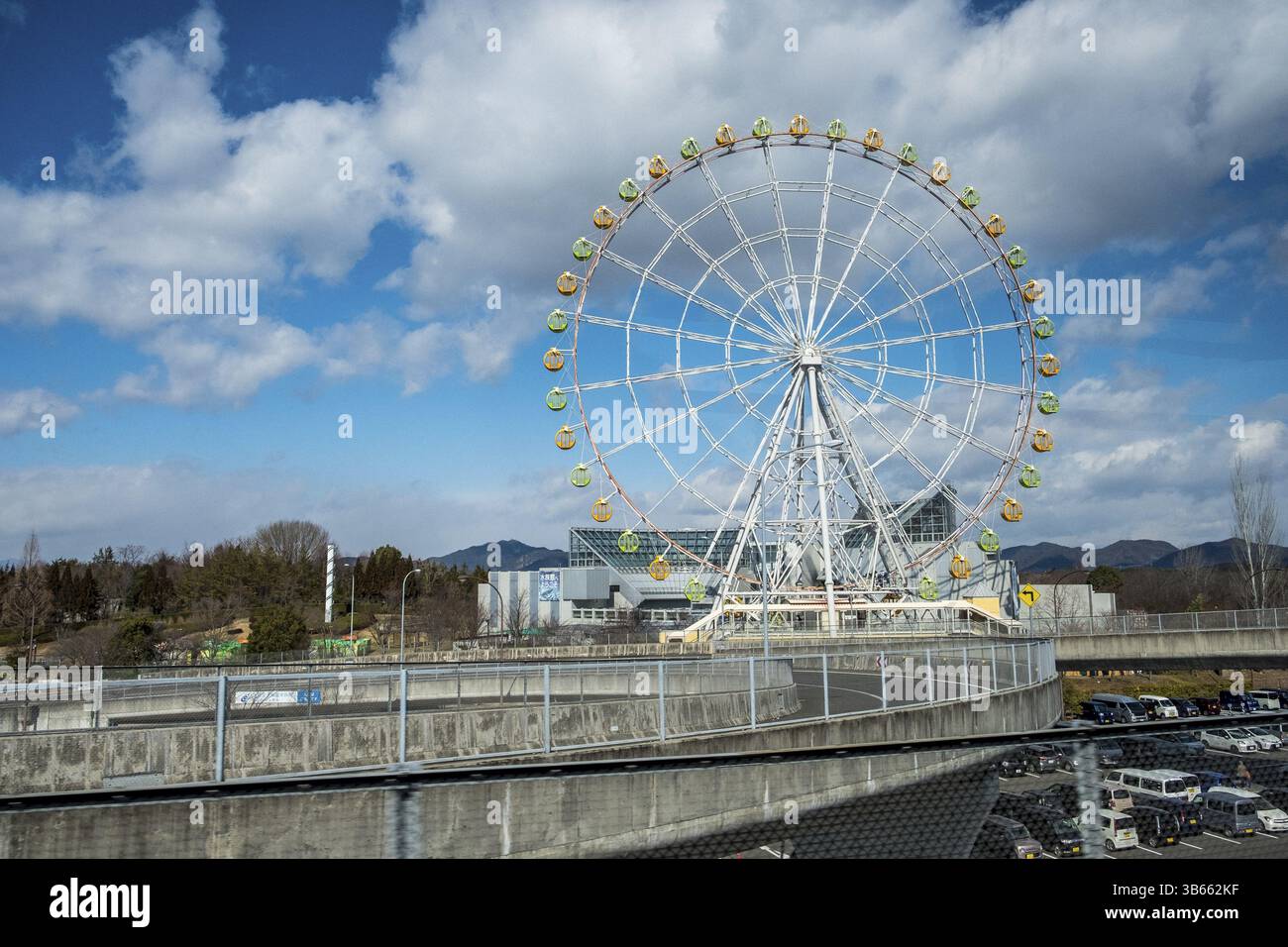 Ferris wheel in Japan with blue sky and clouds Stock Photo - Alamy