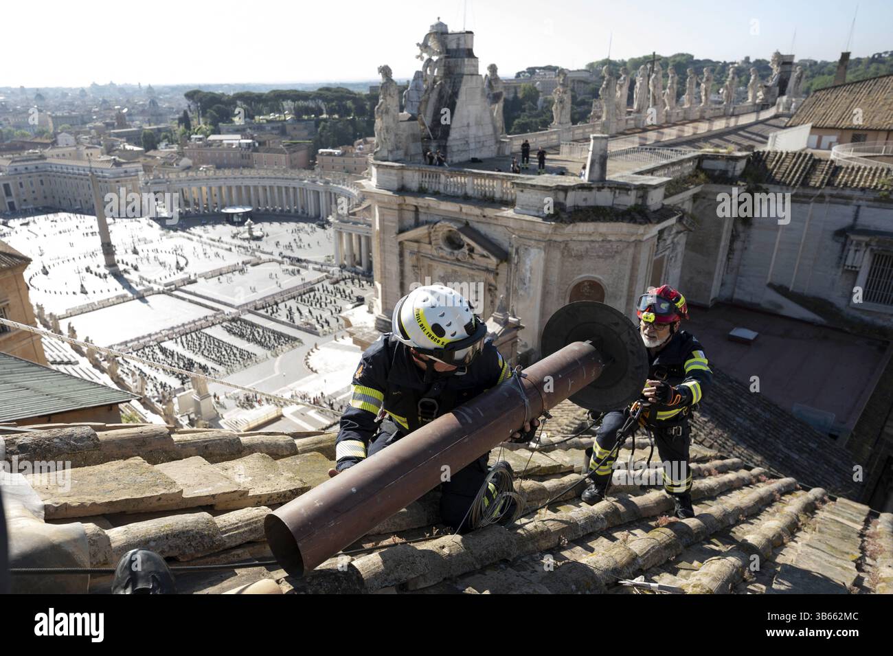 Vatican's firefighters setup the chimney on the roof of the Sistine ...