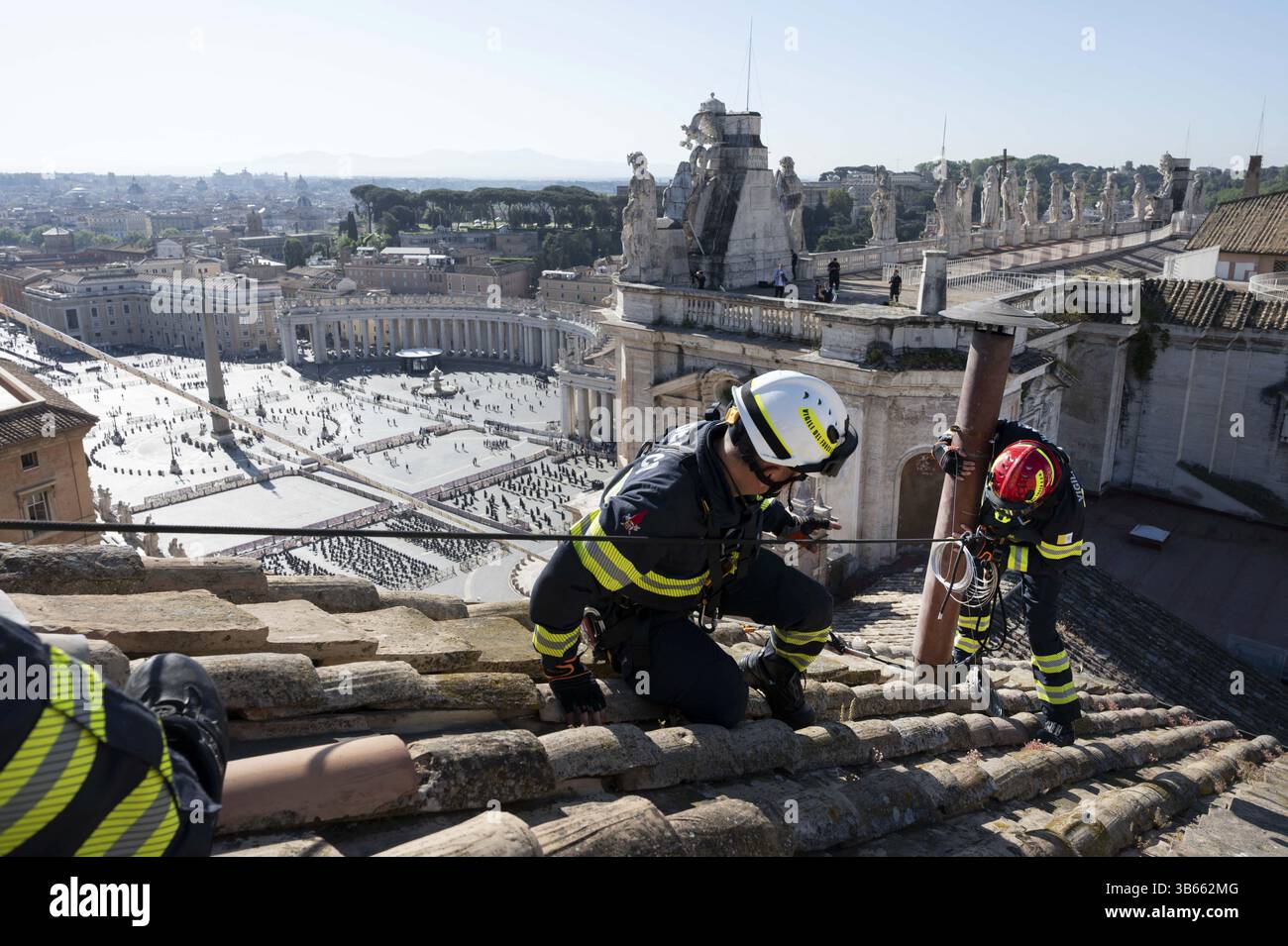Vatican's firefighters setup the chimney on the roof of the Sistine ...