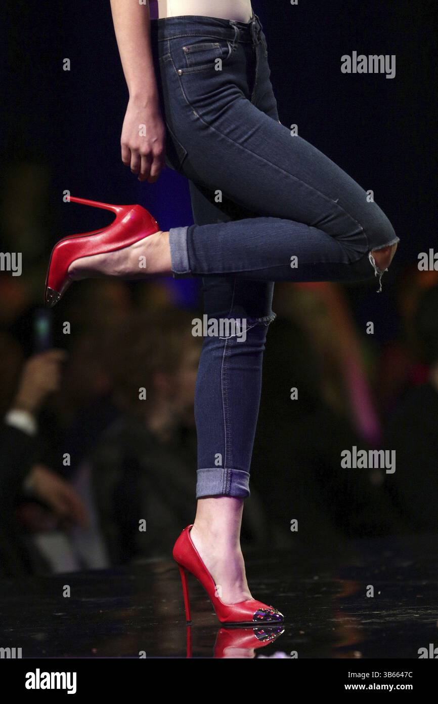 A model walks the runway in stylish red shoes during a Fashion Show ...
