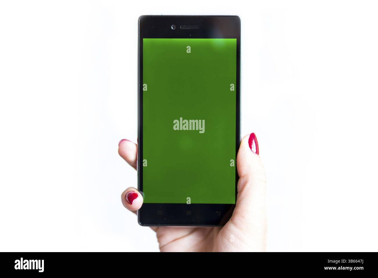 Young woman types and slides on her smartphone isolated on a white ...