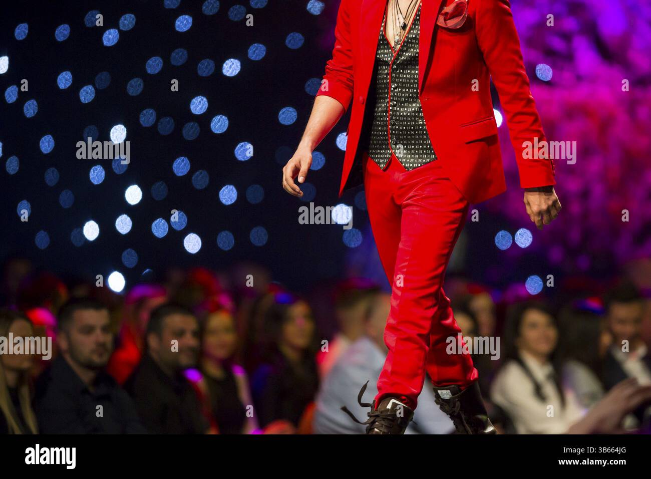 A male model walks the runway in modern red suit during a Fashion Show ...