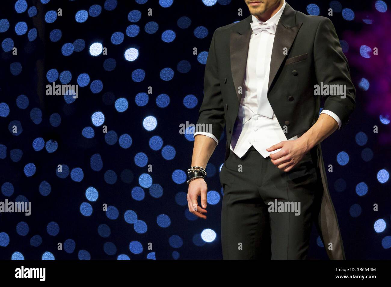A male model walks the runway in stylish modern black business during a ...